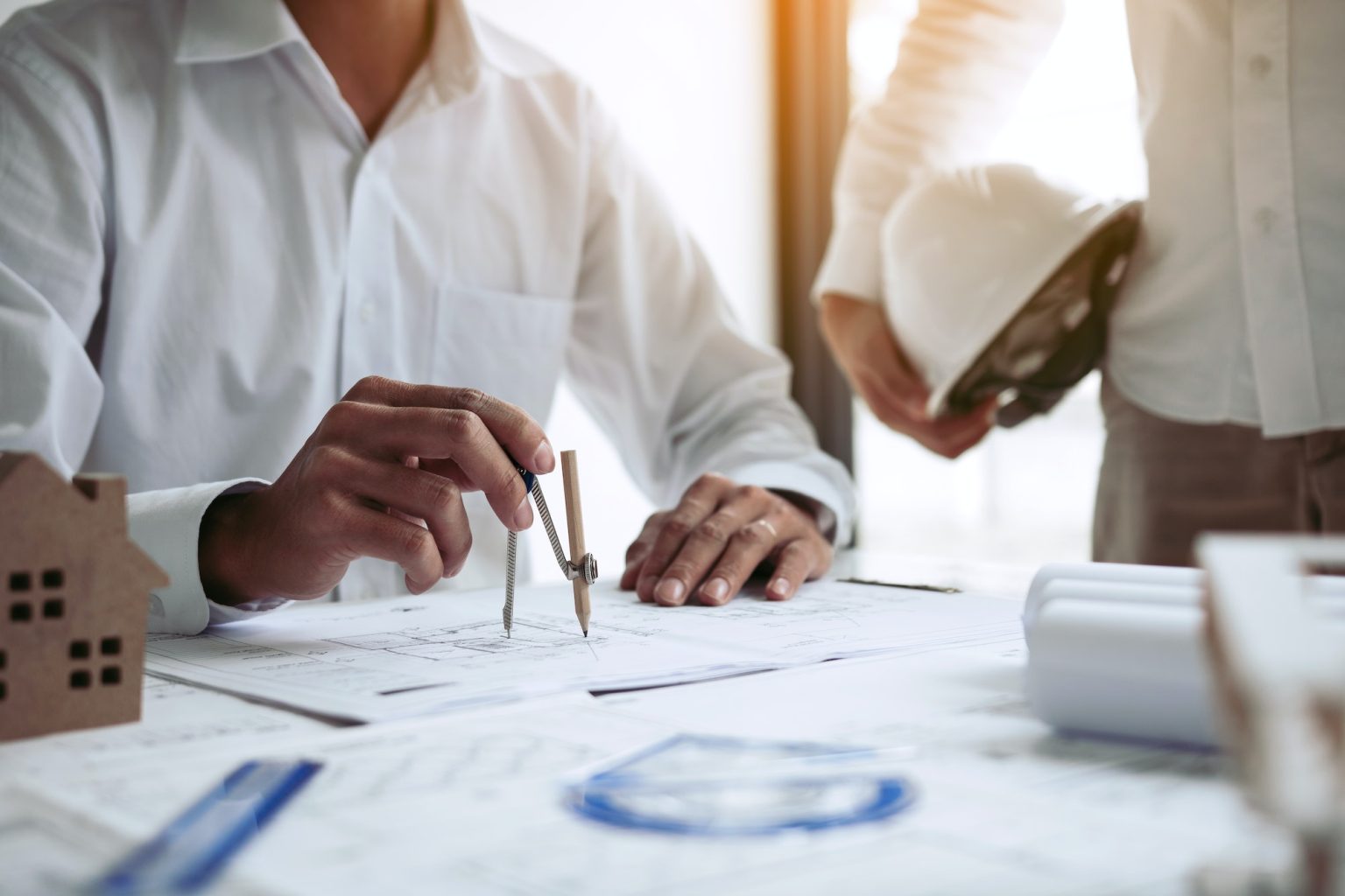 engineering-working-together-and-using-compass-looking-blueprint-and ...